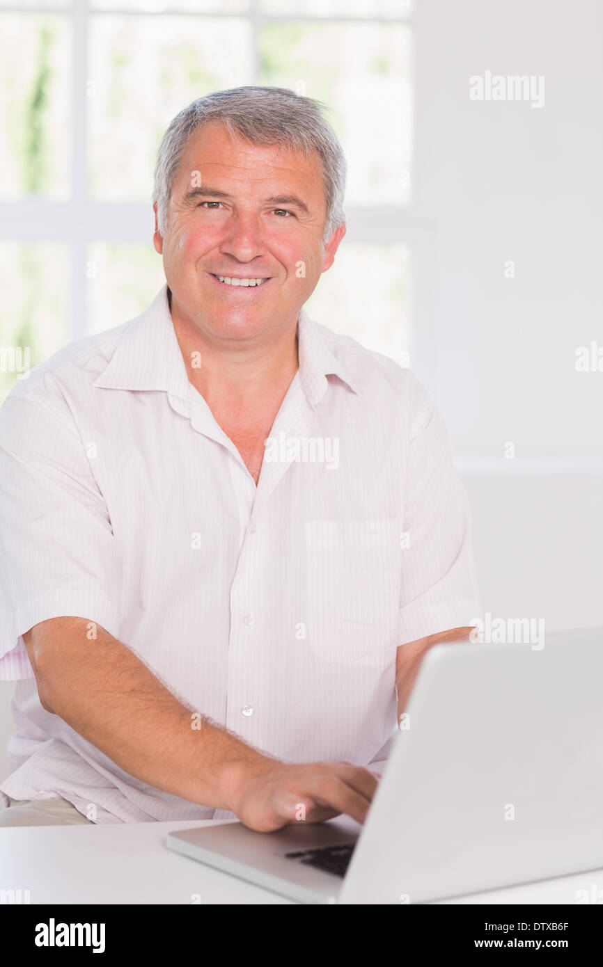 Old man using a white laptop Stock Photo - Alamy