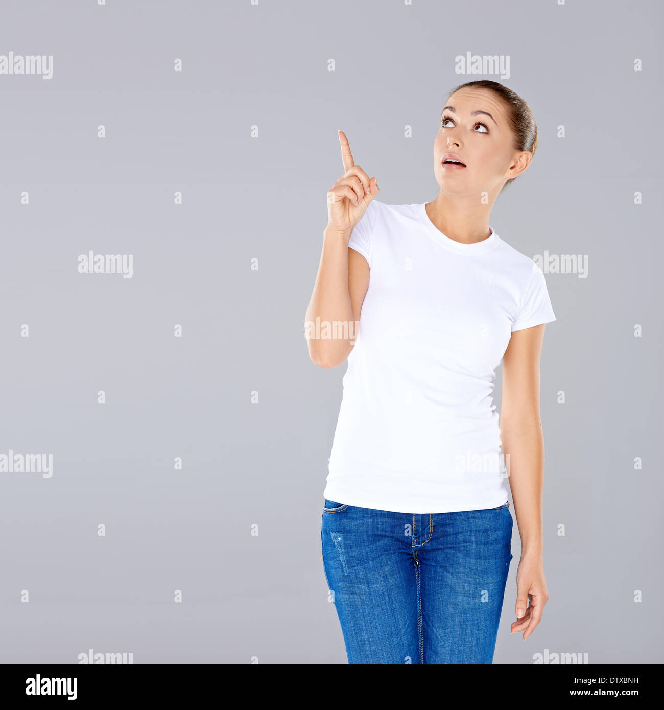 Woman looking up and pointing Stock Photo - Alamy
