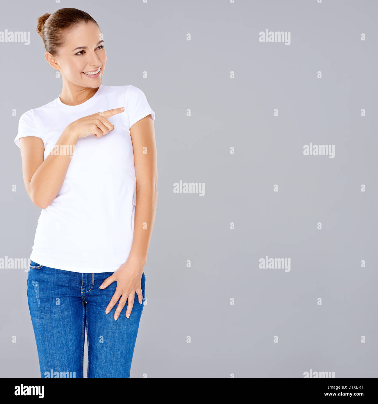 Woman pointing with a smile Stock Photo - Alamy