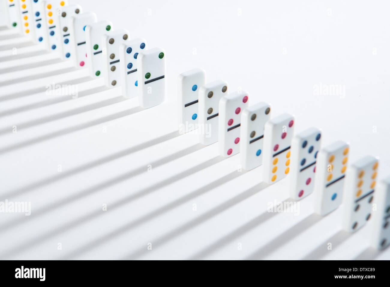 Line of dominoes with one piece missing Stock Photo - Alamy