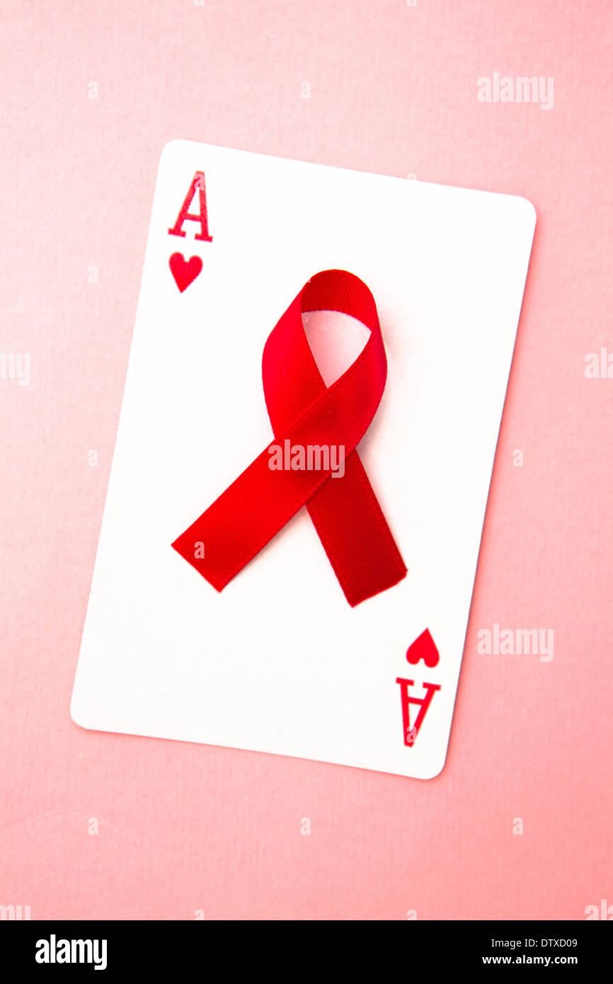 Red awareness ribbon lying on playing card Stock Photo - Alamy