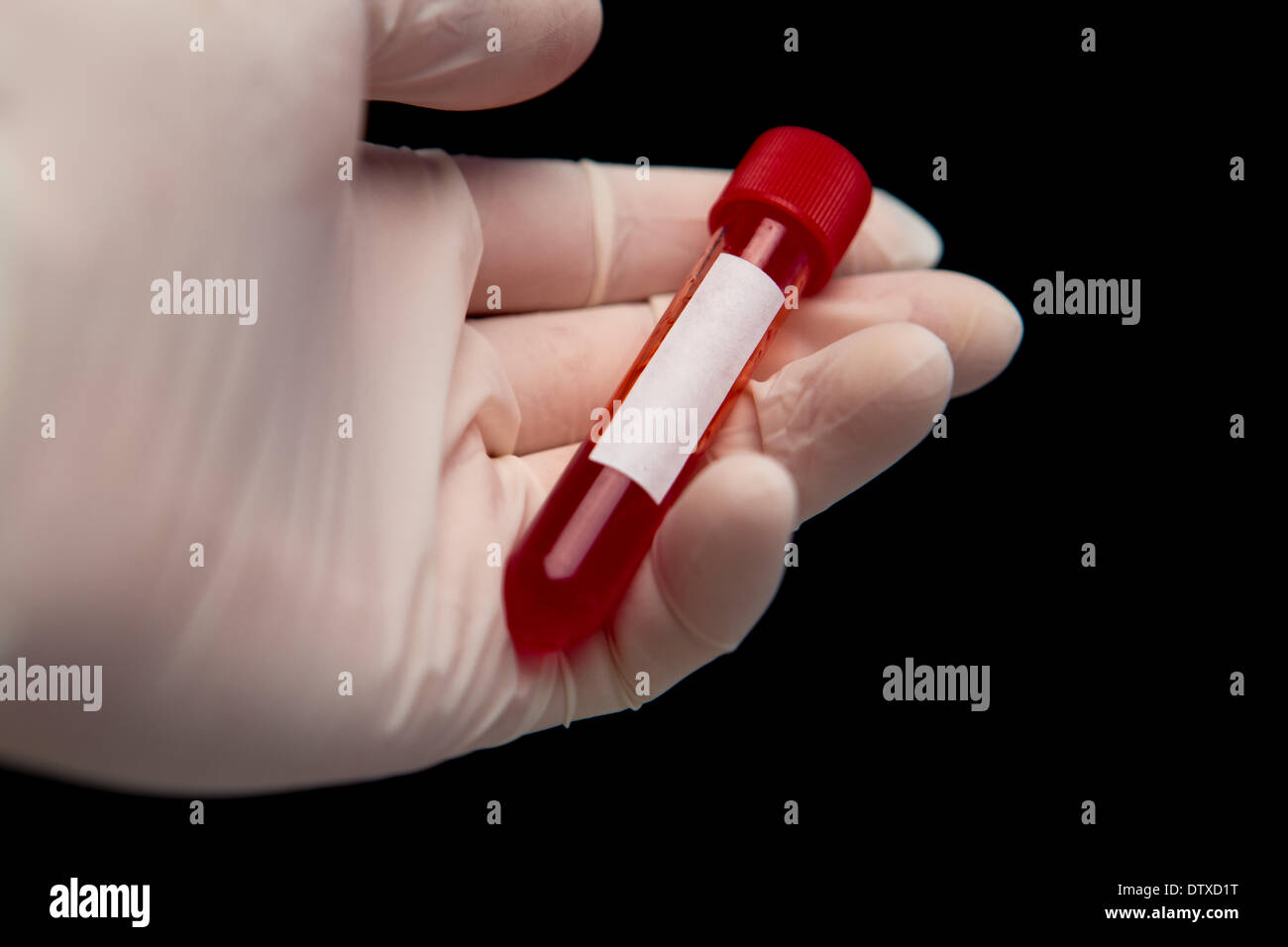 Gloved hand holding vial of blood Stock Photo - Alamy