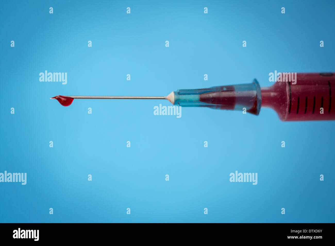 Drop of blood on needle of syringe Stock Photo - Alamy