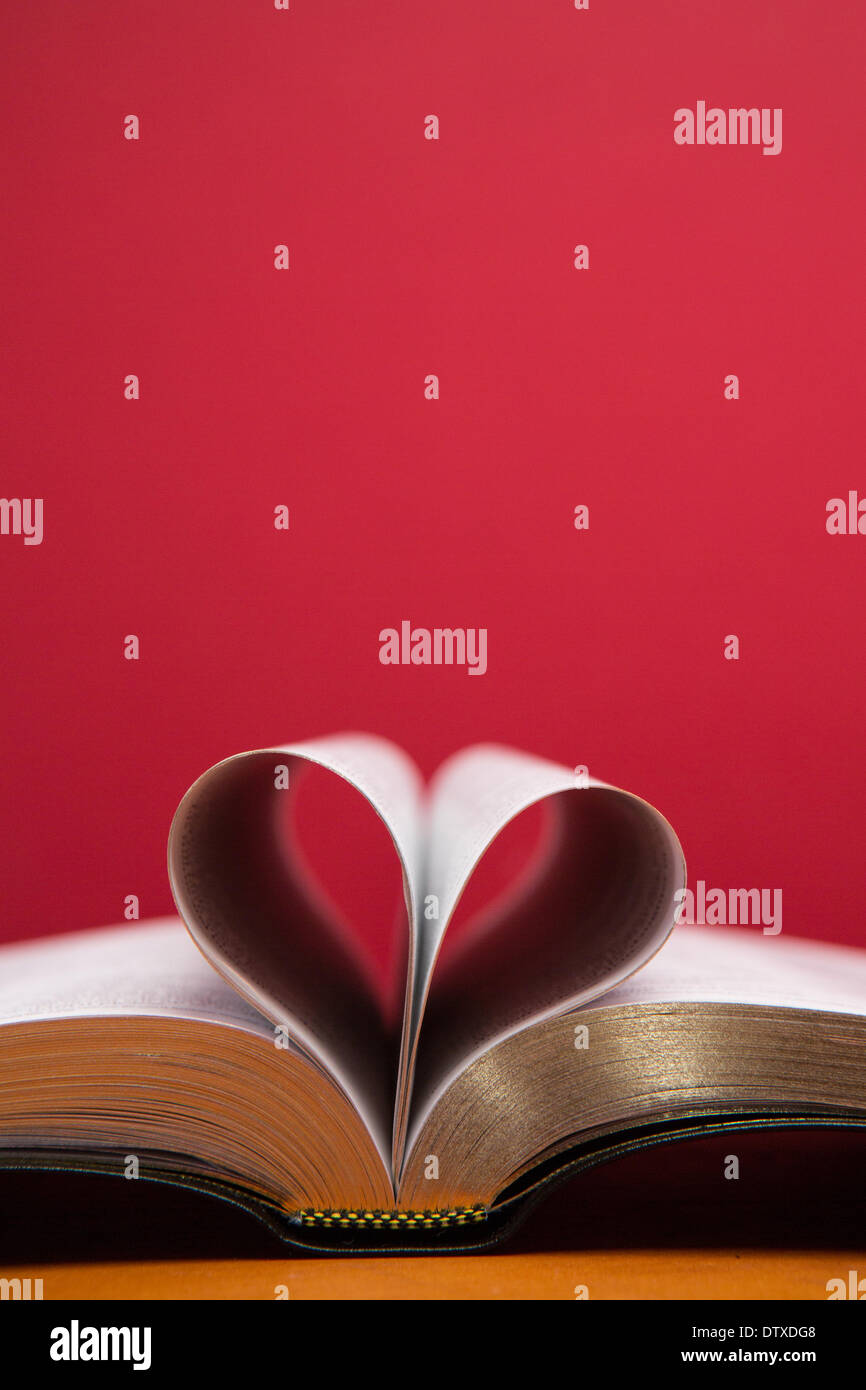 Embossed pages of book folded to make heart Stock Photo - Alamy
