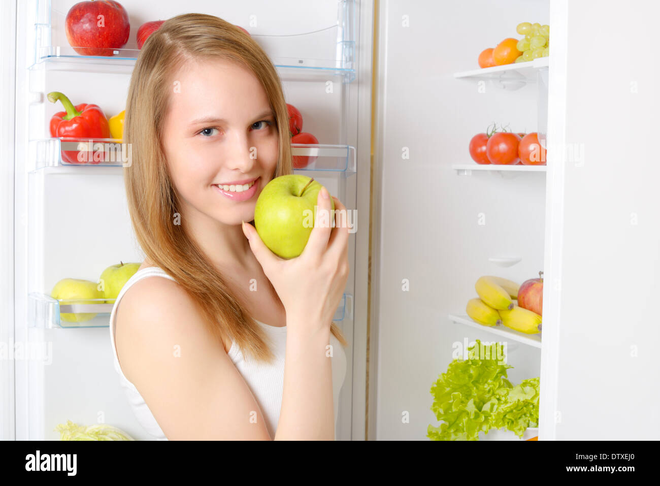 Beautiful smiling girl near the refrigerator Stock Photo - Alamy