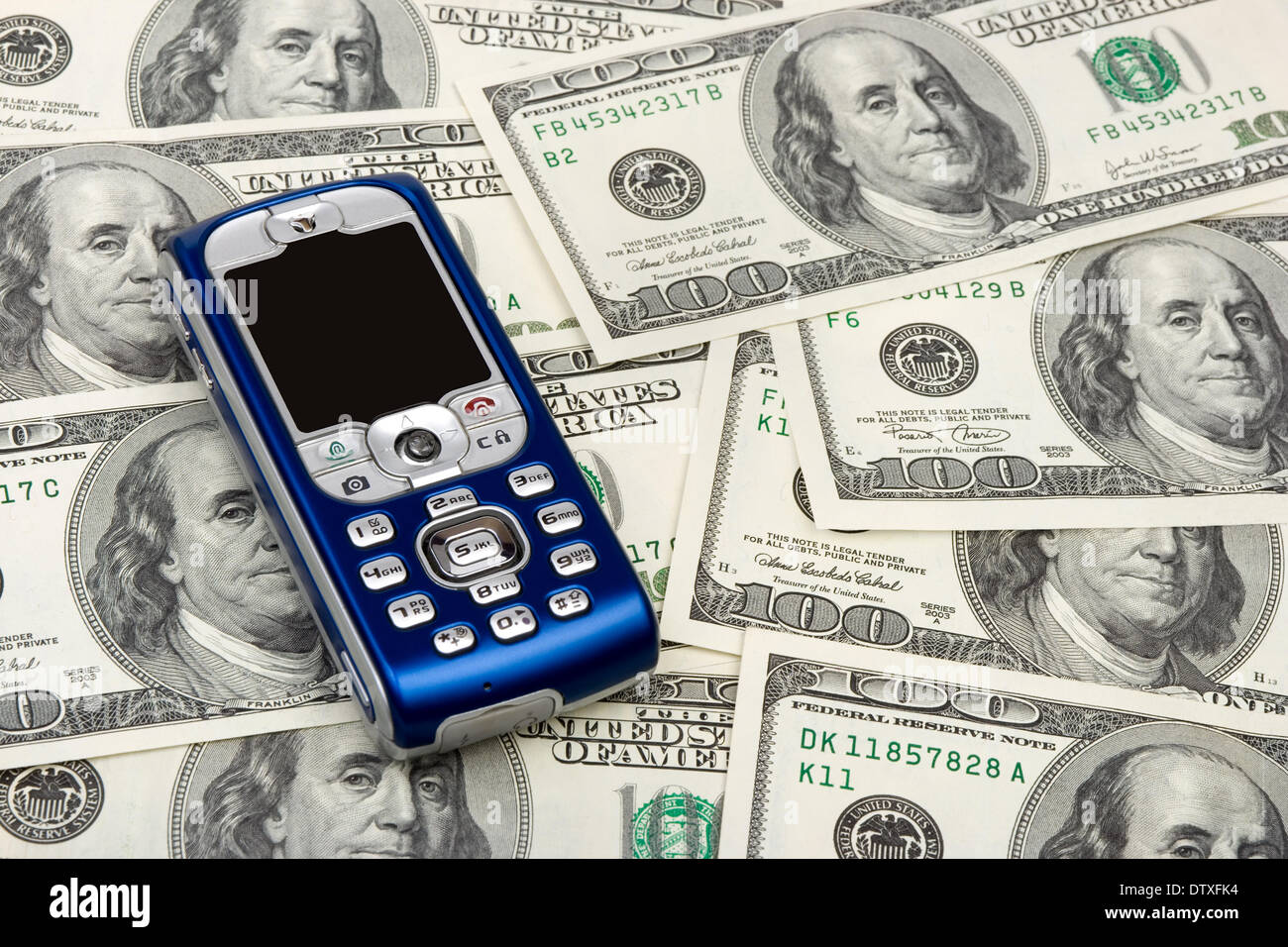 Mobile phone on money background Stock Photo - Alamy