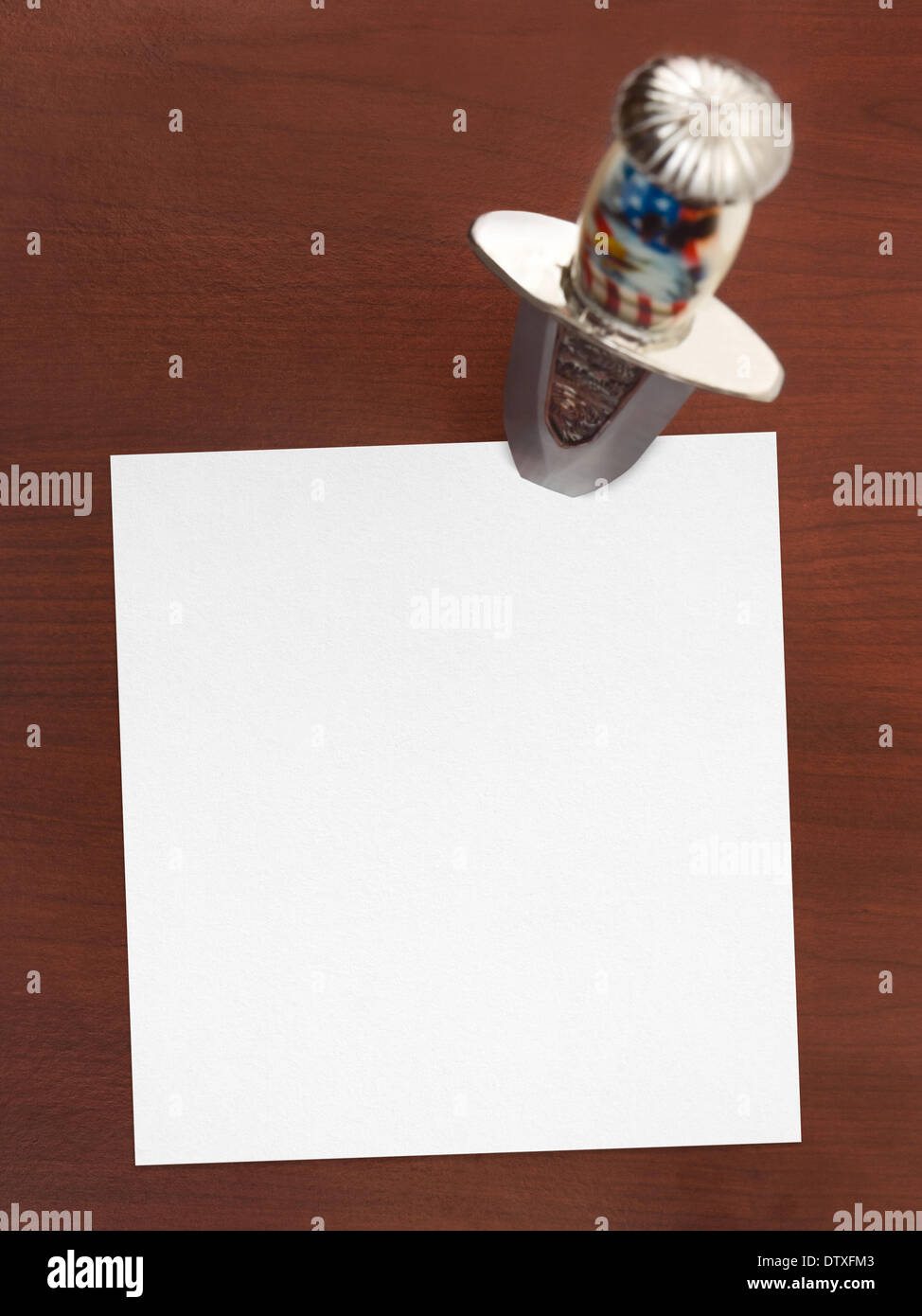 Paper background and a dagger Stock Photo - Alamy