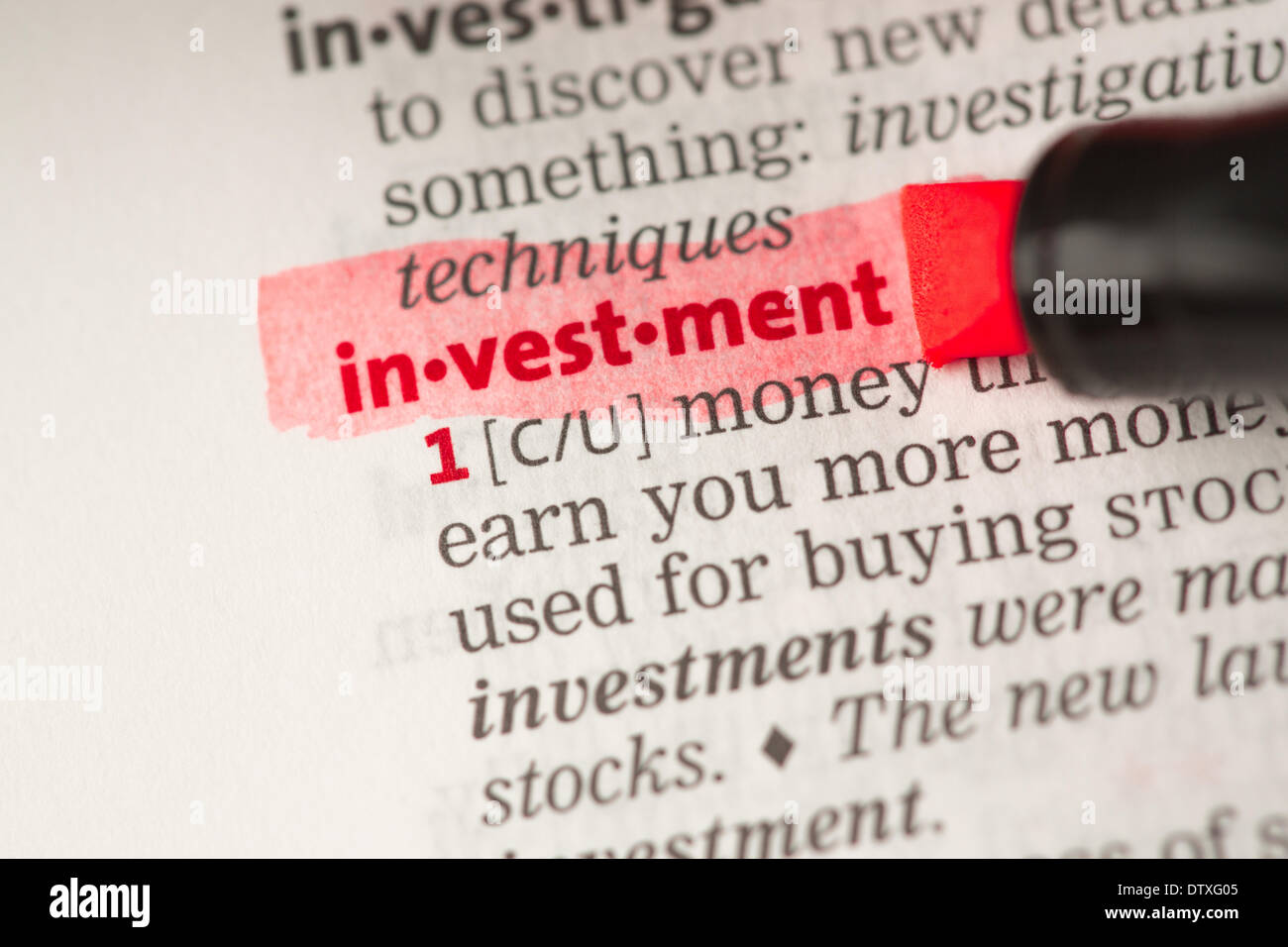 Investment definition highlighted in red Stock Photo - Alamy