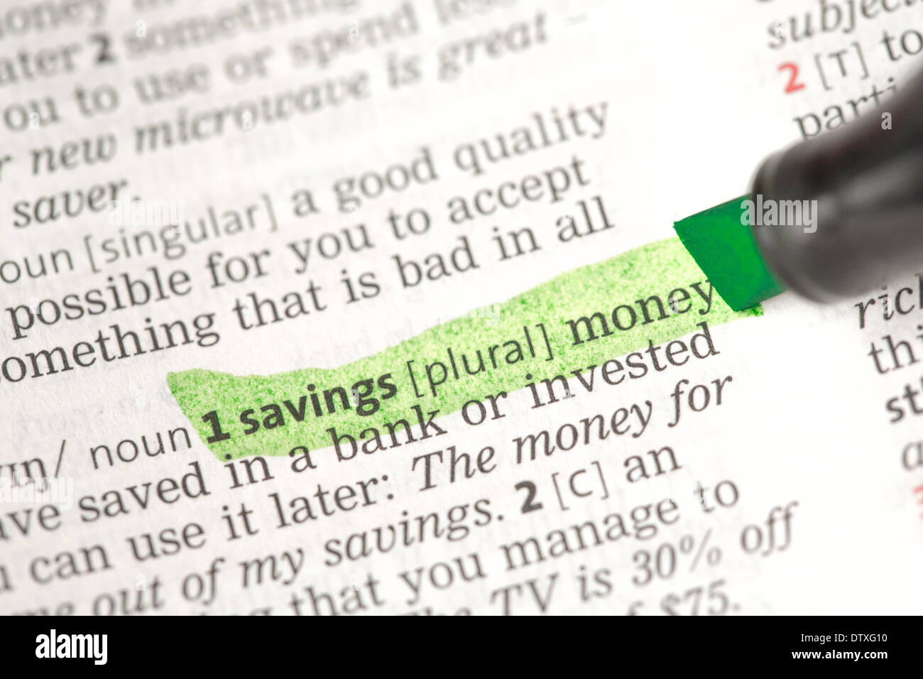 Savings money definition highlighted in green Stock Photo - Alamy