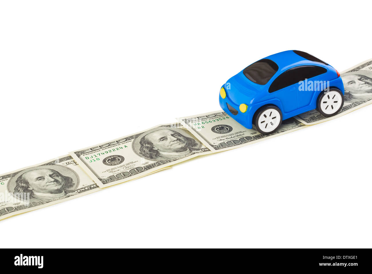 Toy car on money road Stock Photo - Alamy