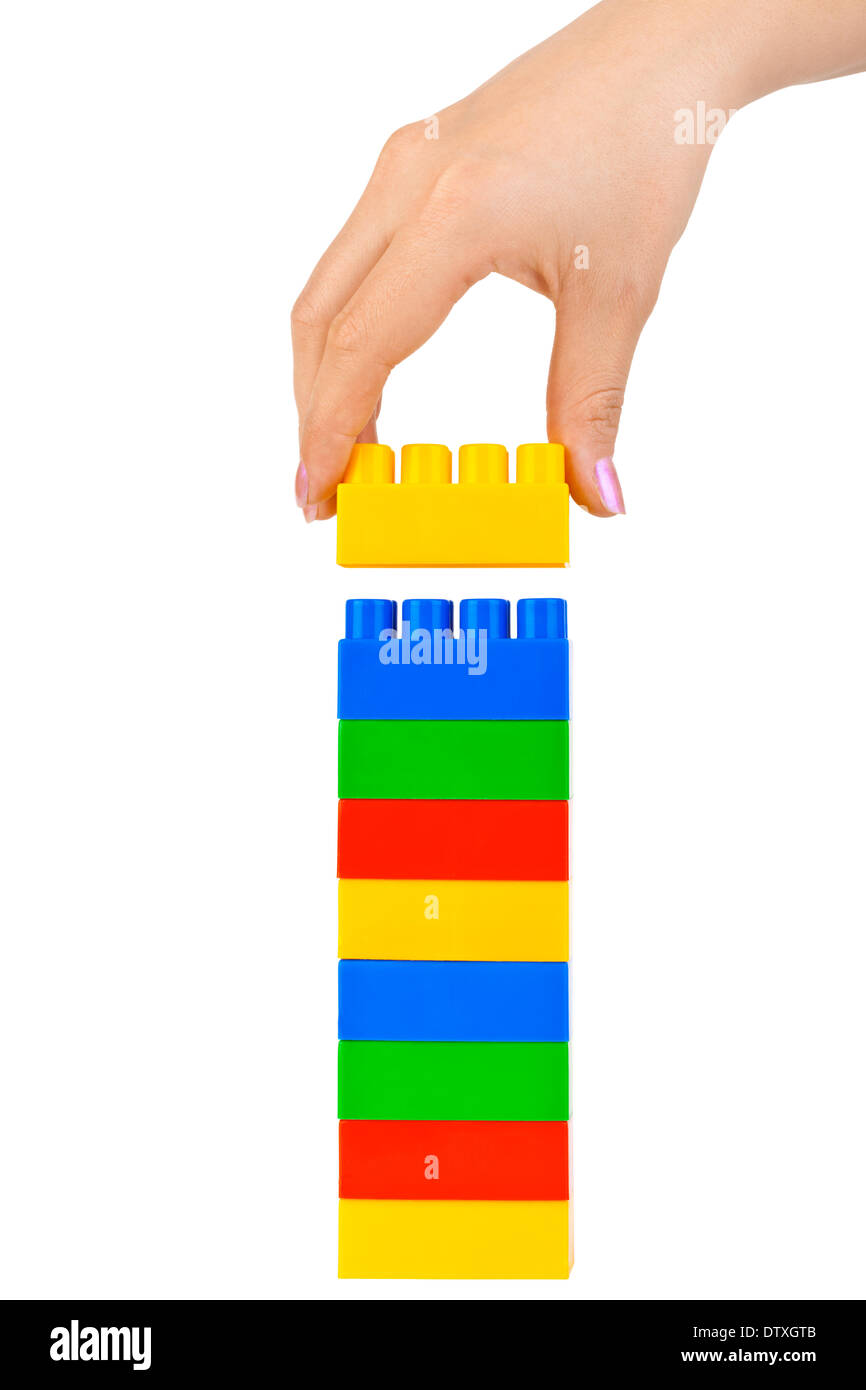 Hand and toy tower Stock Photo - Alamy