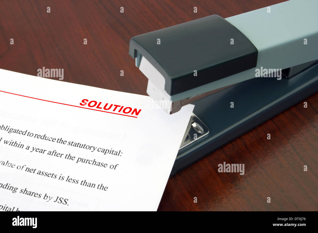 Office stapler and document Solution Stock Photo - Alamy