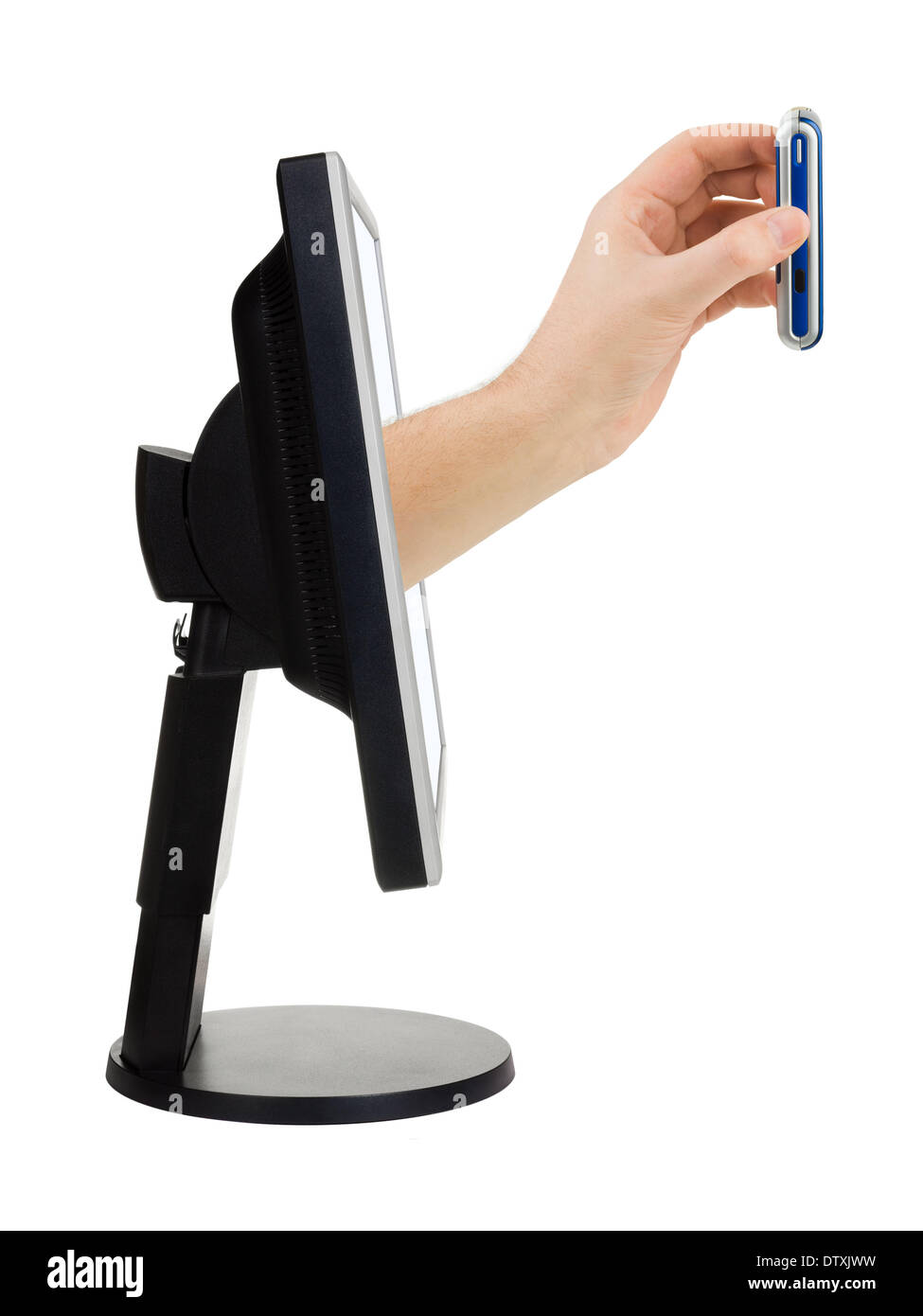 Computer screen and hand with phone Stock Photo - Alamy