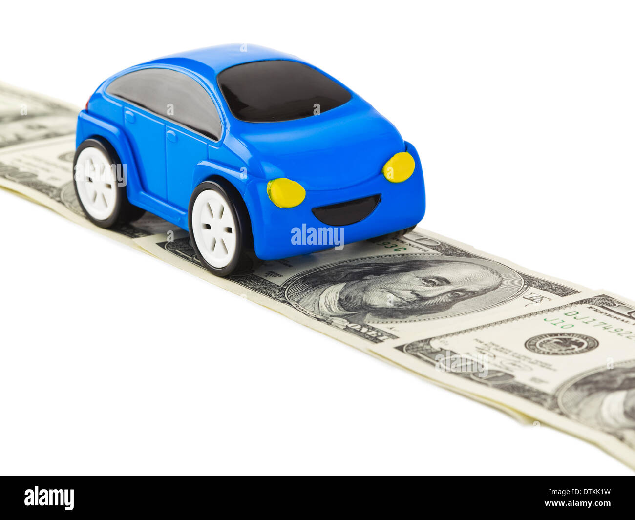 Toy car on money road Stock Photo - Alamy