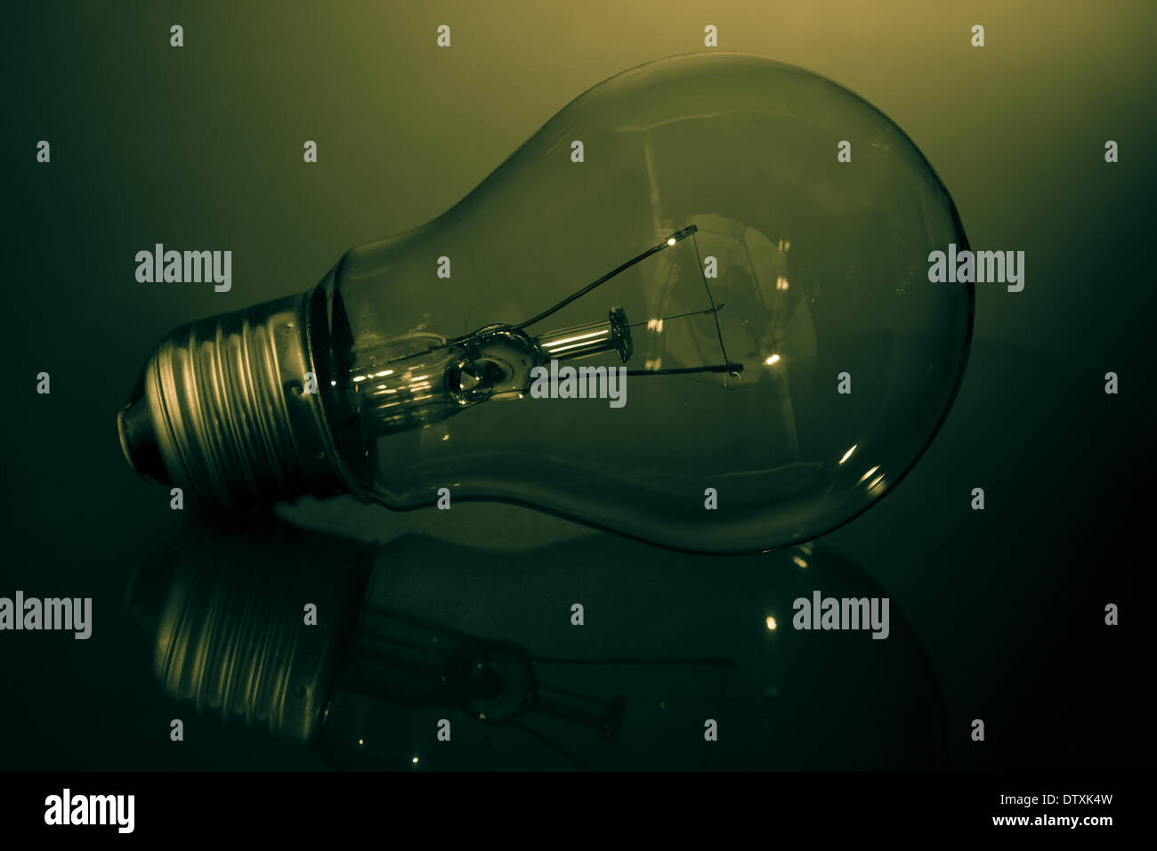Clear light bulb in green light Stock Photo - Alamy