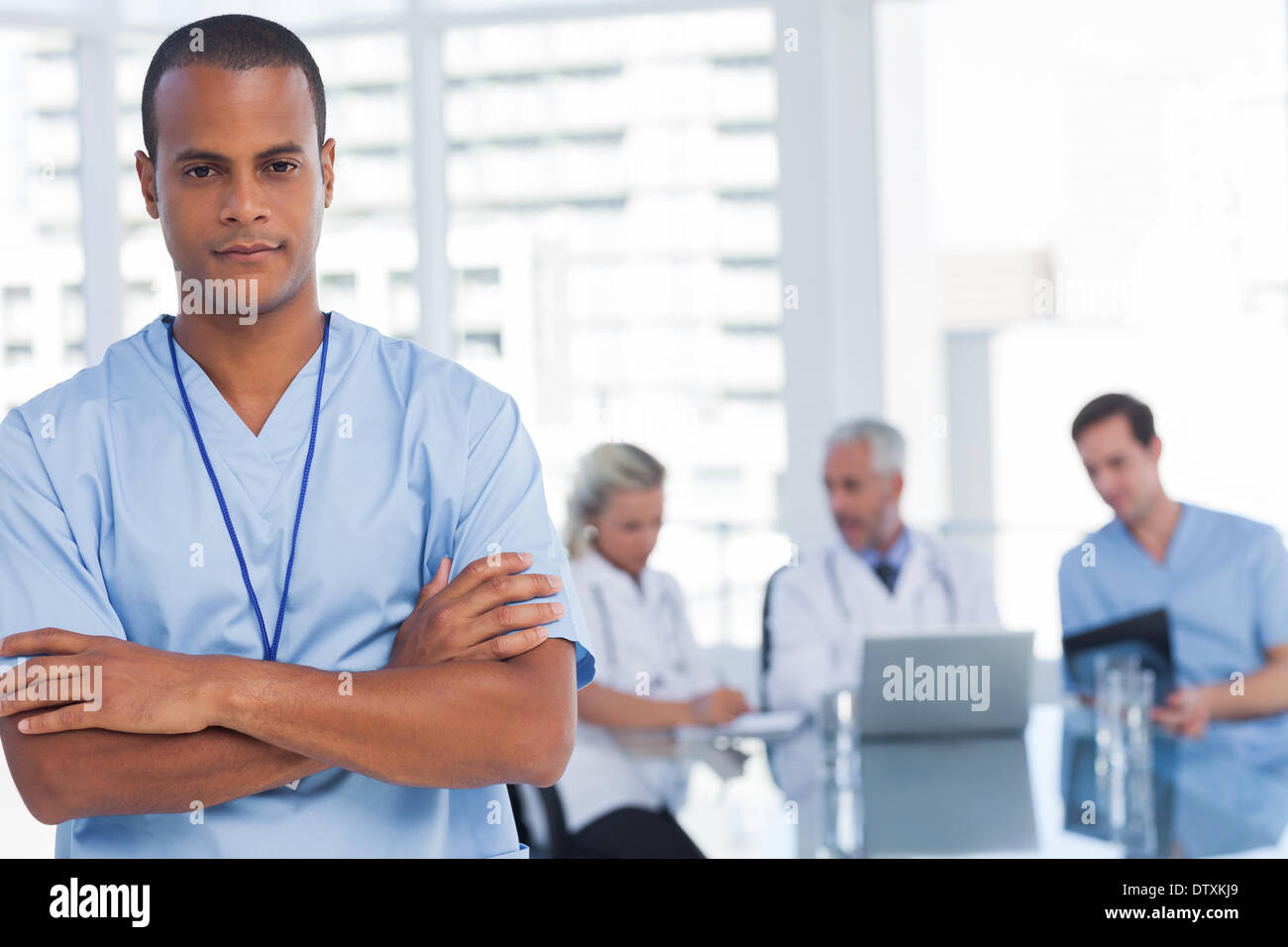 Serious doctor with arms crossed Stock Photo - Alamy