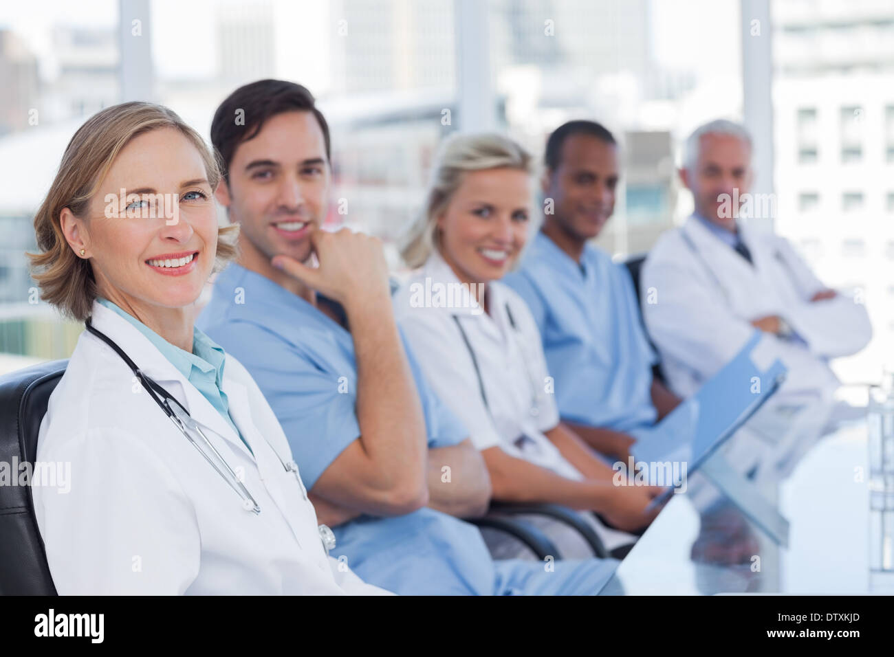 Medical team sitting in row Stock Photo - Alamy