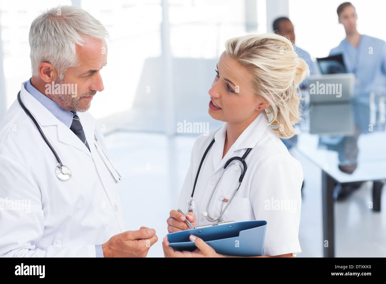 Two doctors speaking Stock Photo - Alamy