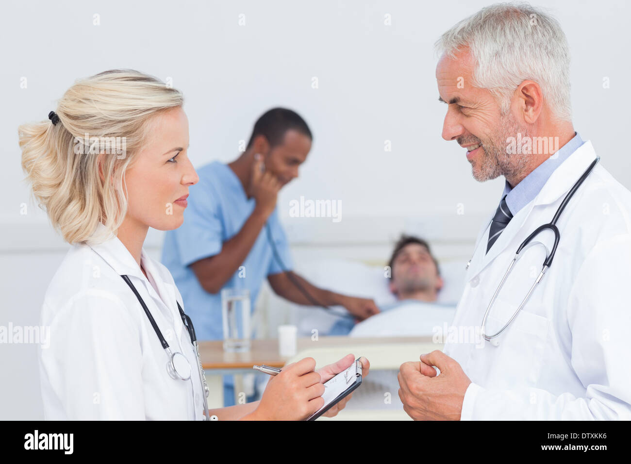Smiling doctors speaking together Stock Photo - Alamy