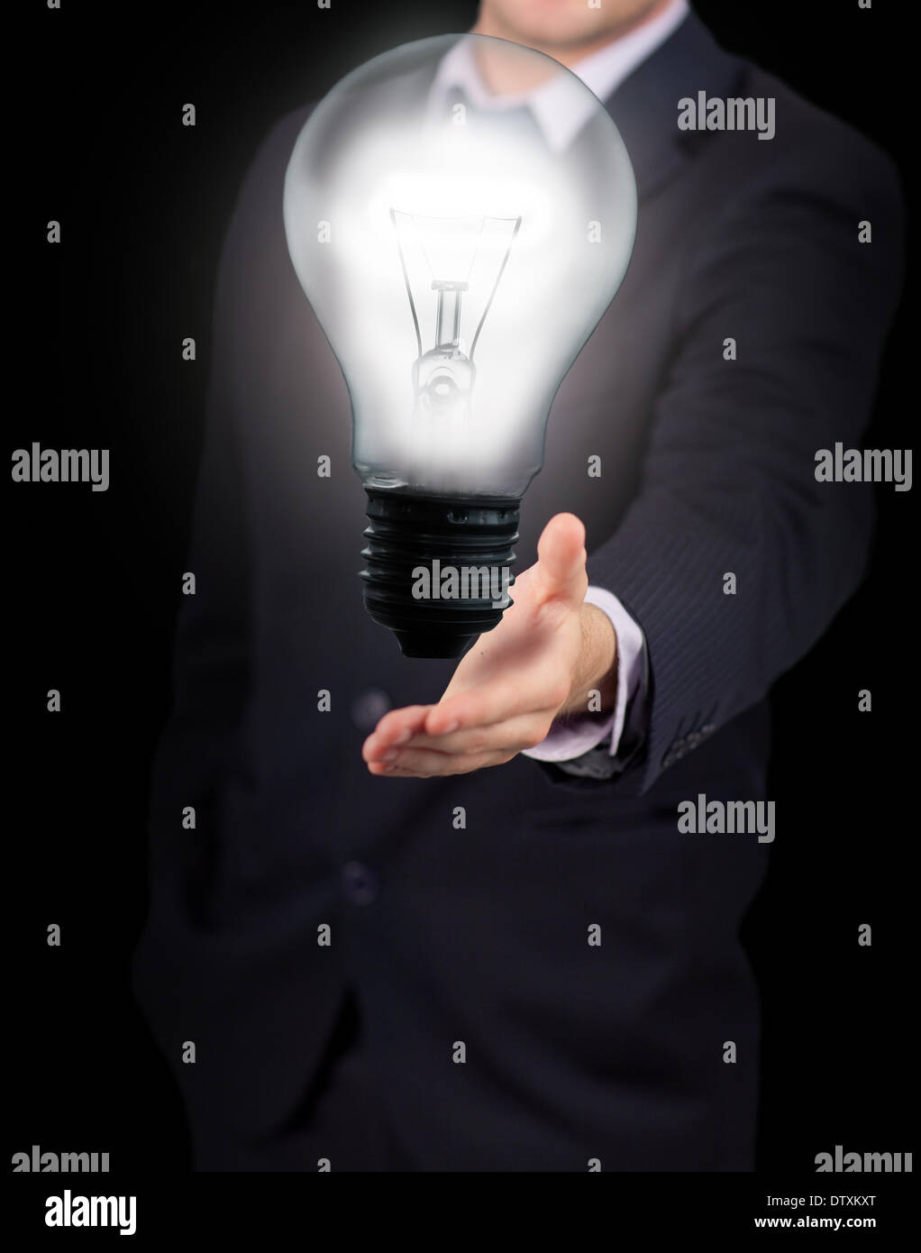 Businessman holding big light bulb lighting Stock Photo - Alamy