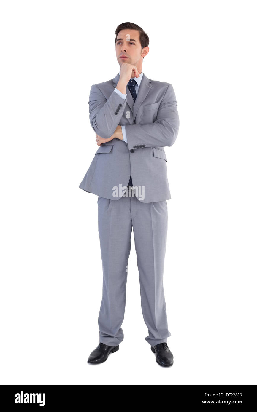 Serious businessman standing and thinking Stock Photo - Alamy
