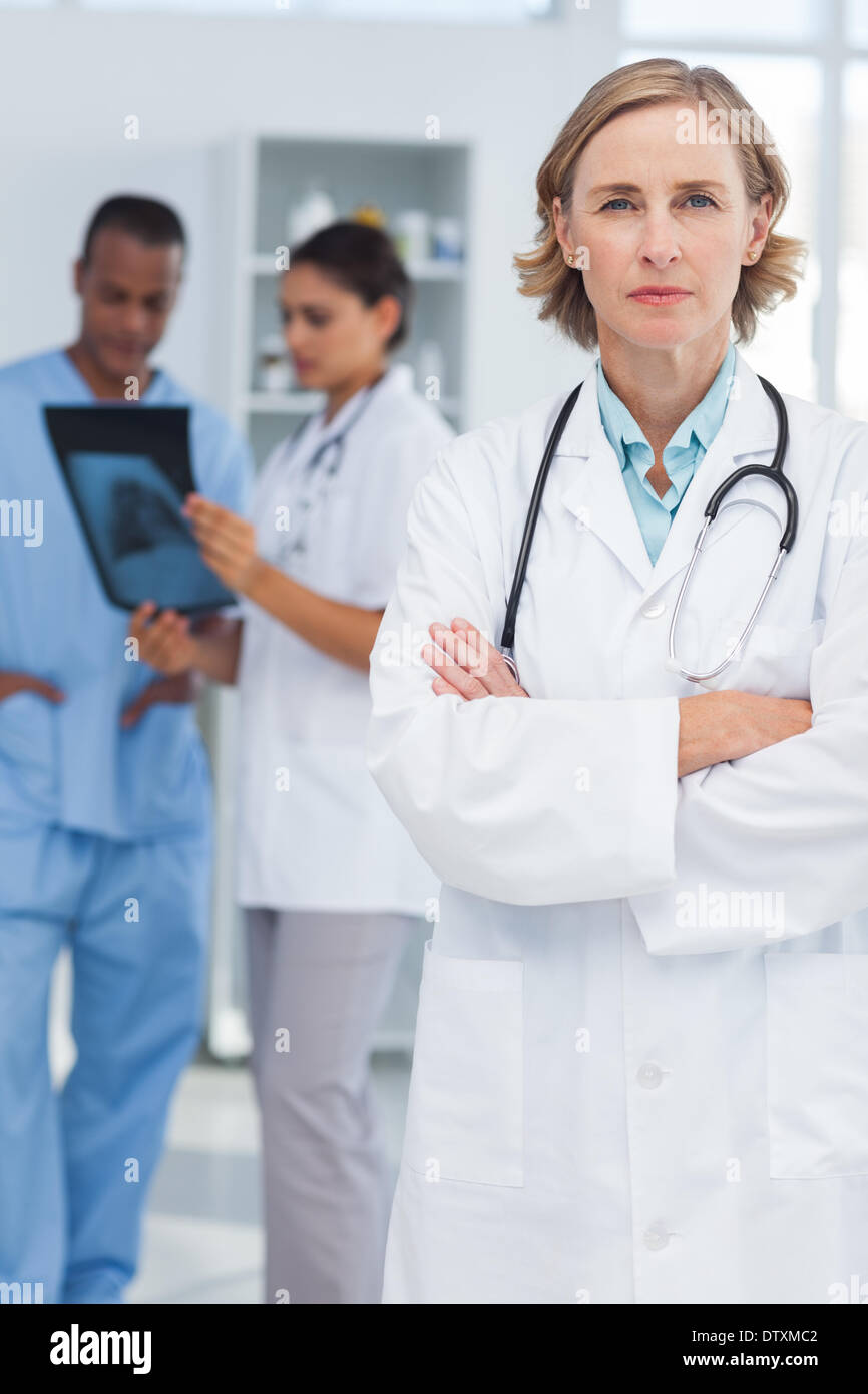 Serious doctor folded arms hi-res stock photography and images - Alamy