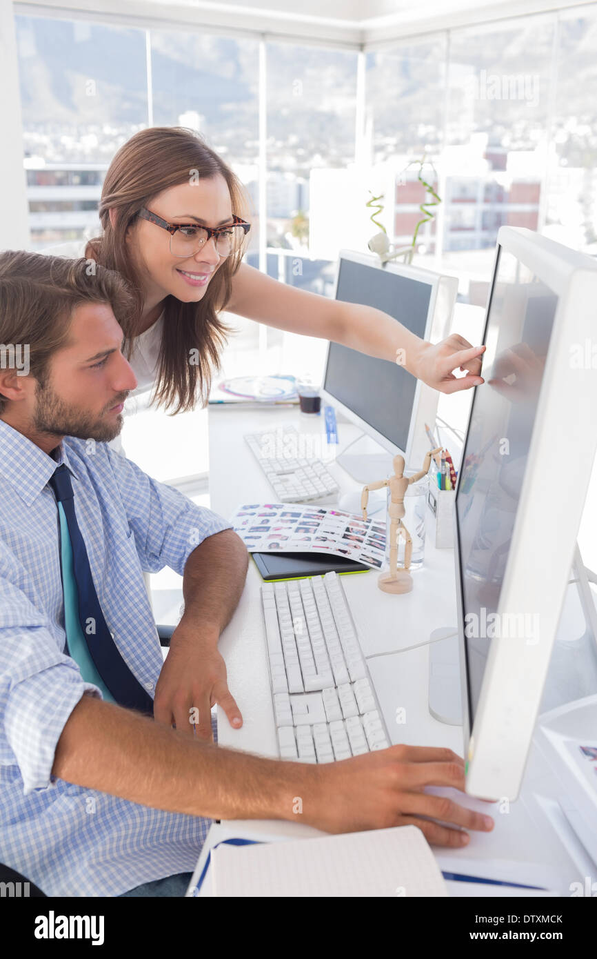 Editors reviewing photographs on computer Stock Photo - Alamy