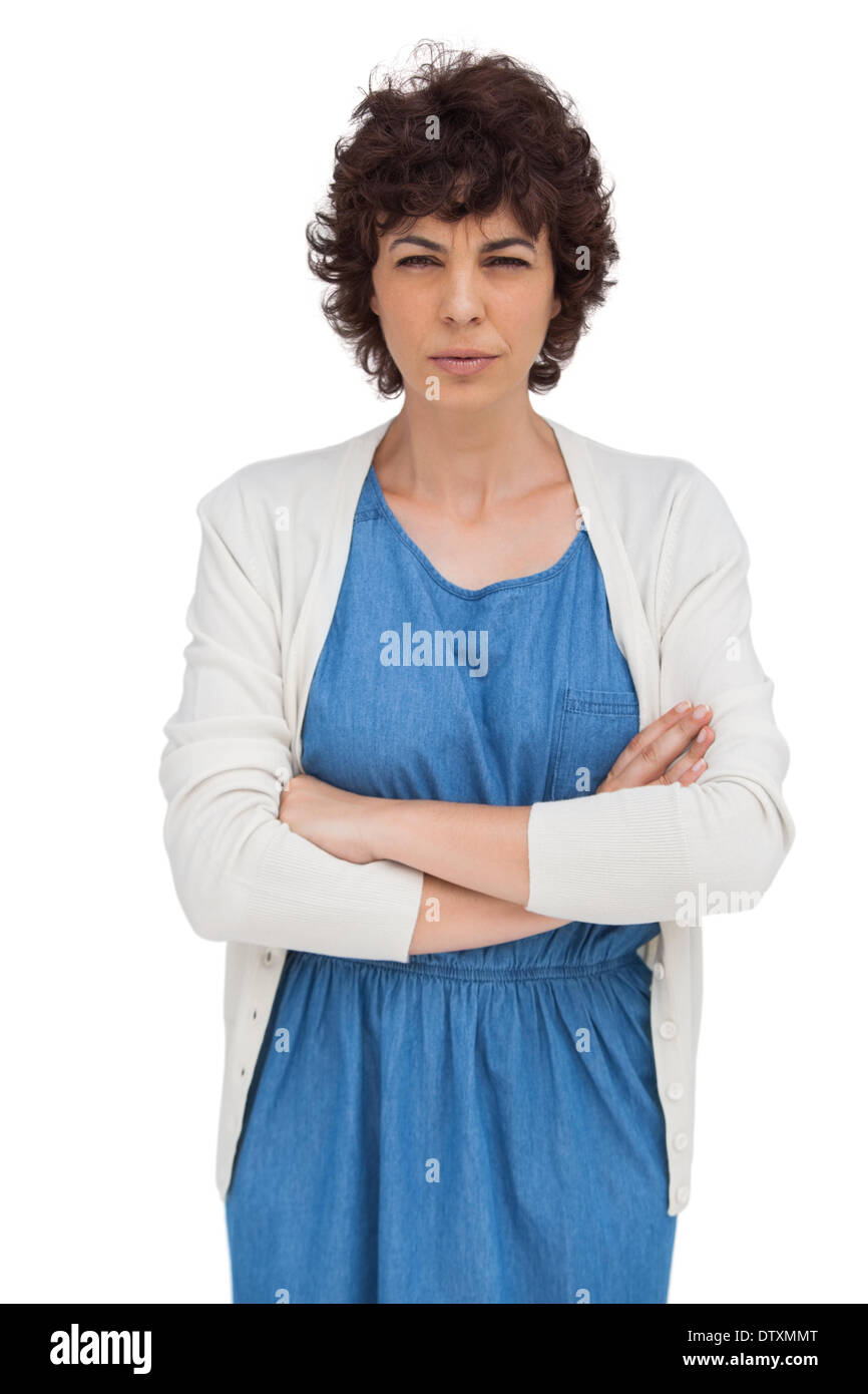 Serious brunette woman with arms folded Stock Photo - Alamy