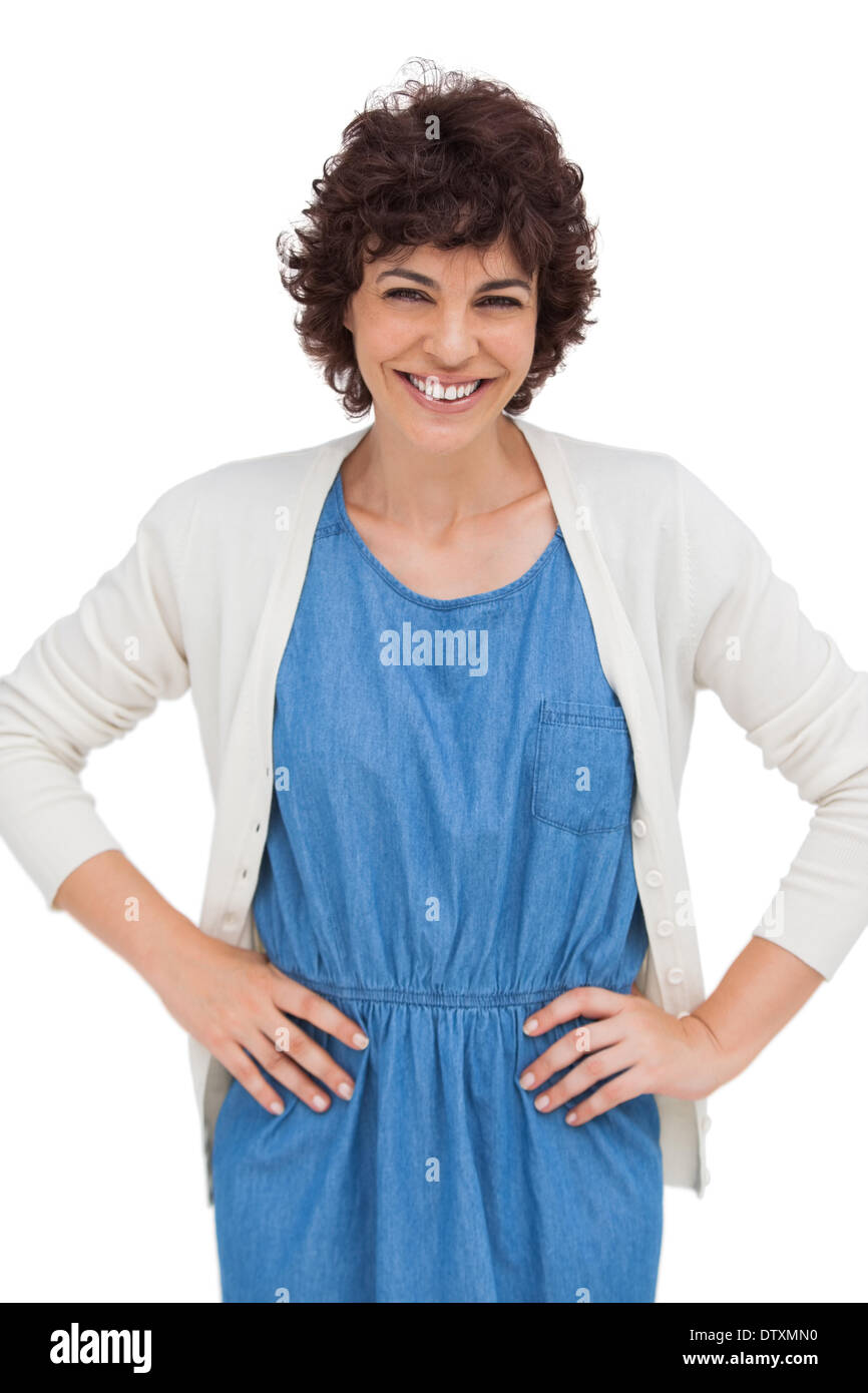 Smiling brunette woman placing hands on hips Stock Photo - Alamy