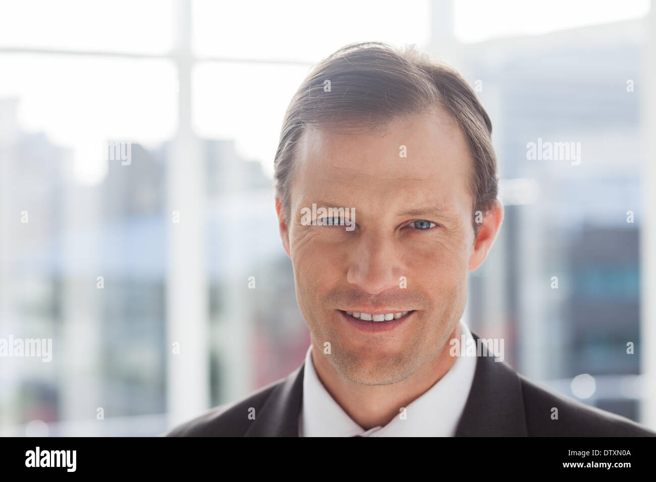 Close up of confident businessman standing Stock Photo - Alamy