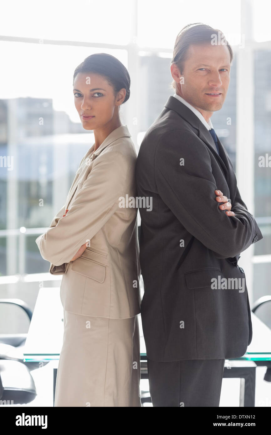 Business people standing back to back Stock Photo - Alamy