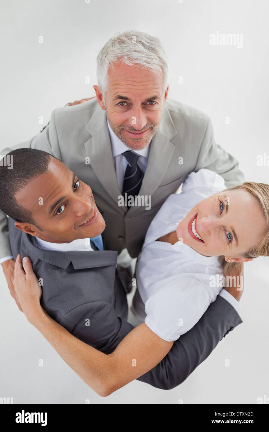 Business people embracing together Stock Photo - Alamy