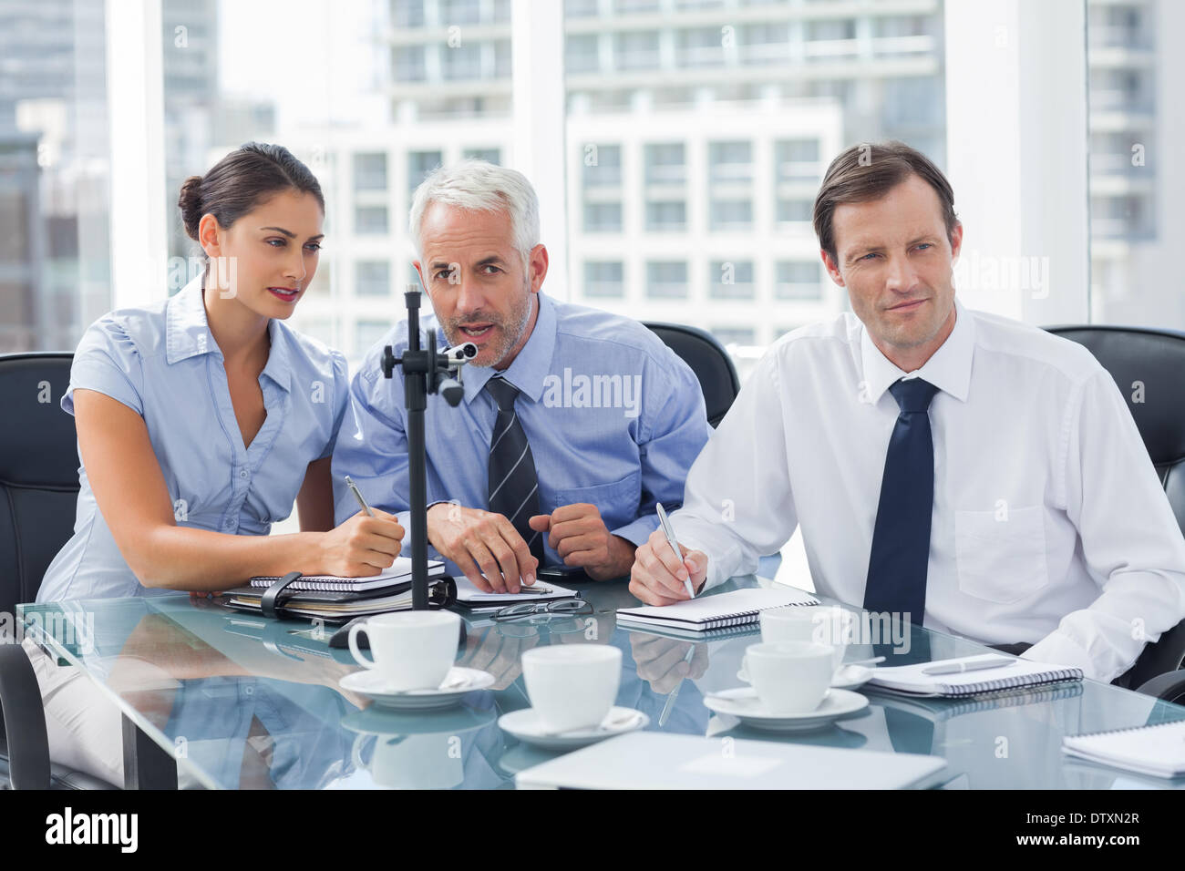 Businessman speaking in a microphone Stock Photo - Alamy