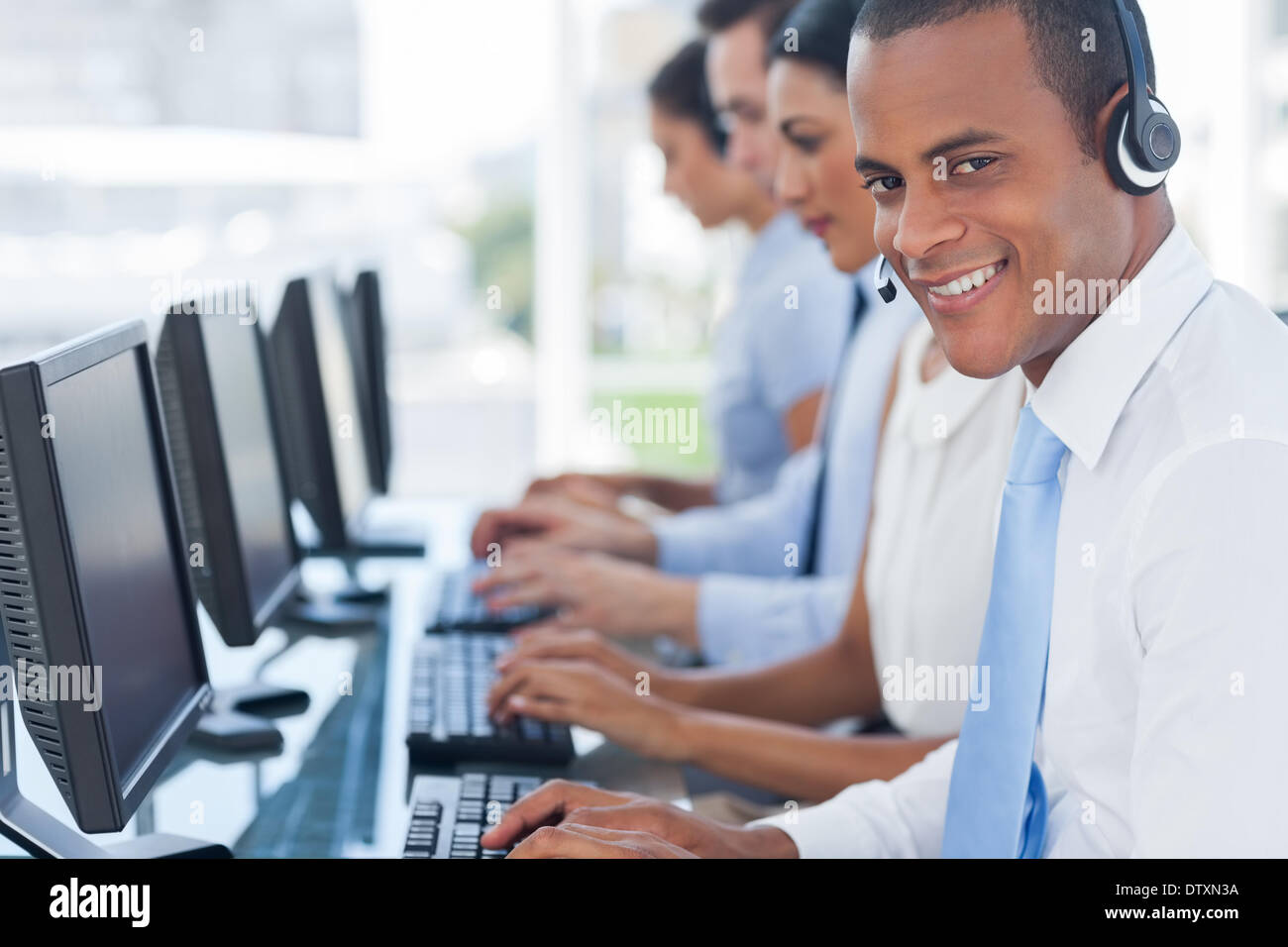 Call centre agent smiling camera hi-res stock photography and images ...
