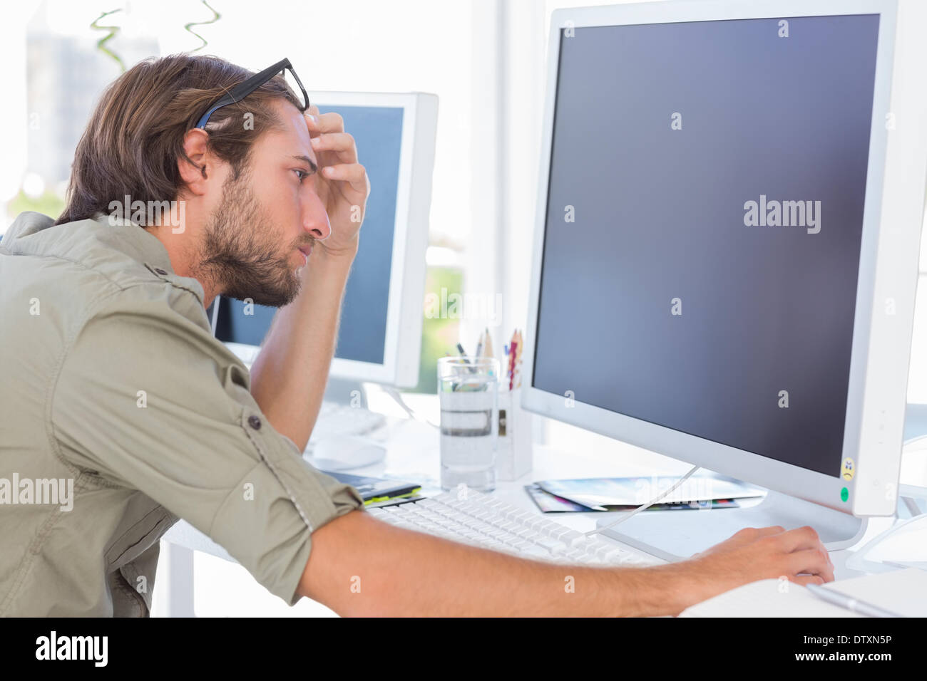 Graphic artist looking at his screen Stock Photo - Alamy