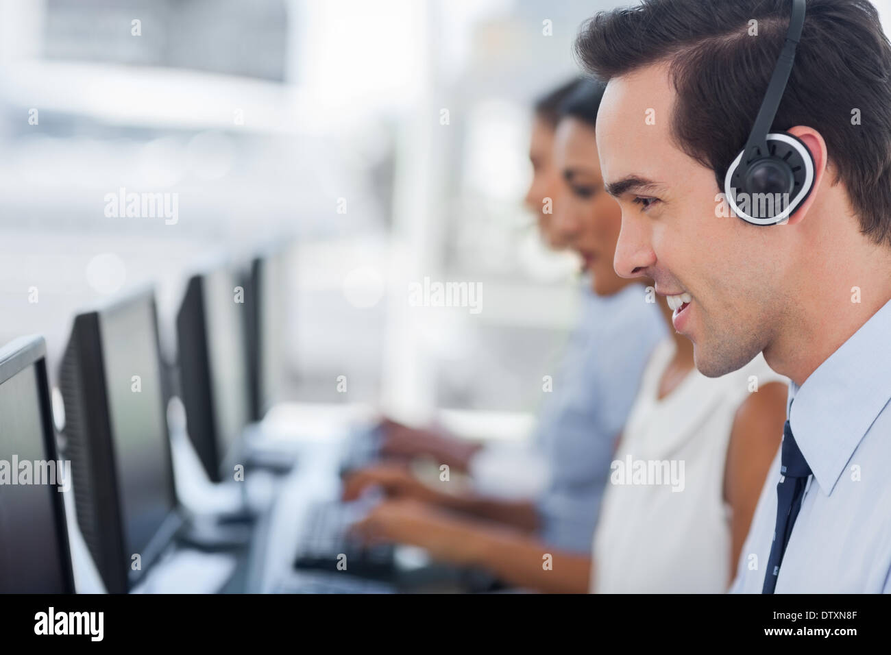 Call centre agent talking typing hi-res stock photography and images ...