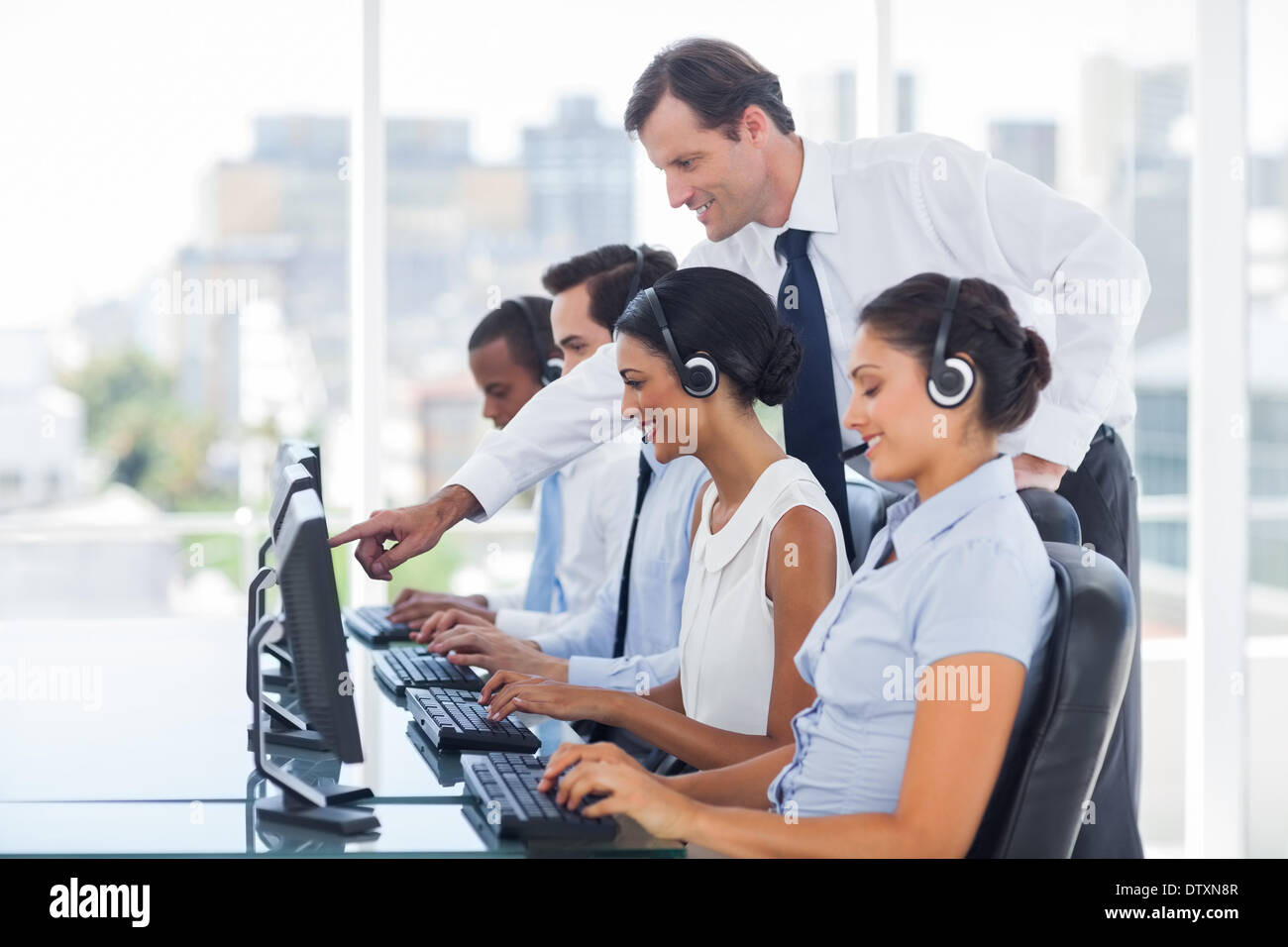 Manager explaining something to his employee Stock Photo - Alamy