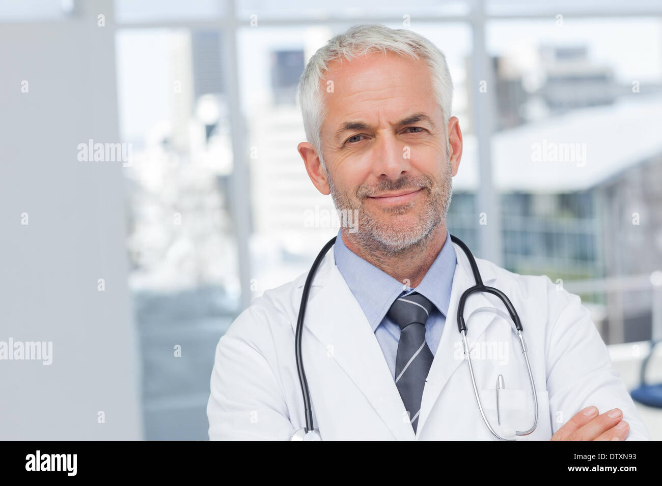 Serious doctor with arms crossed Stock Photo - Alamy