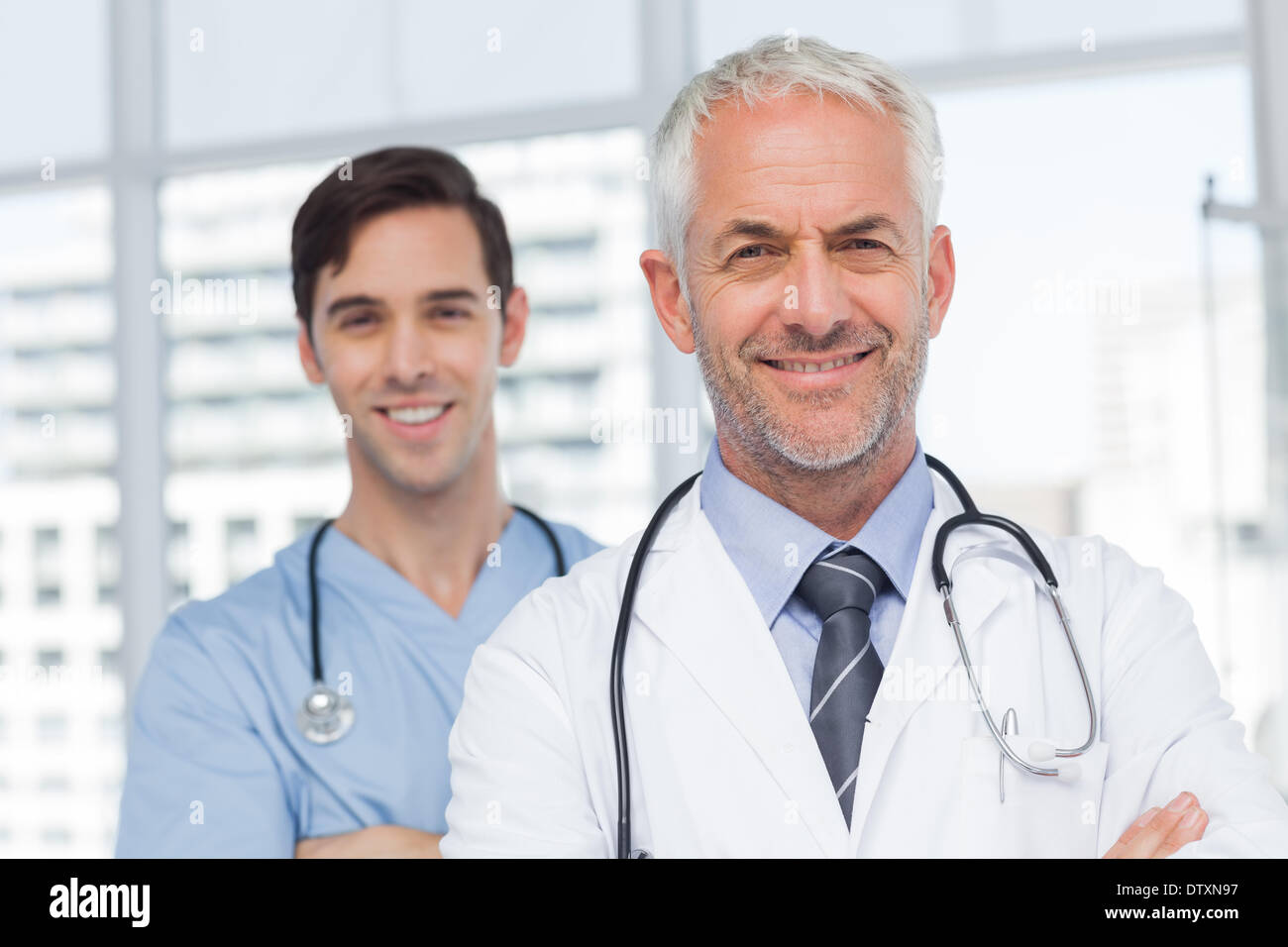 Two smiling doctors standing Stock Photo - Alamy