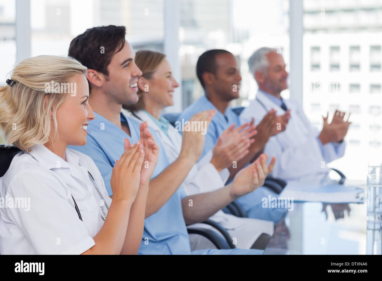 Medical team clapping their hands Stock Photo - Alamy