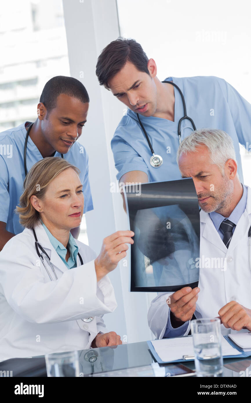 Serious medical team examining radiography Stock Photo - Alamy