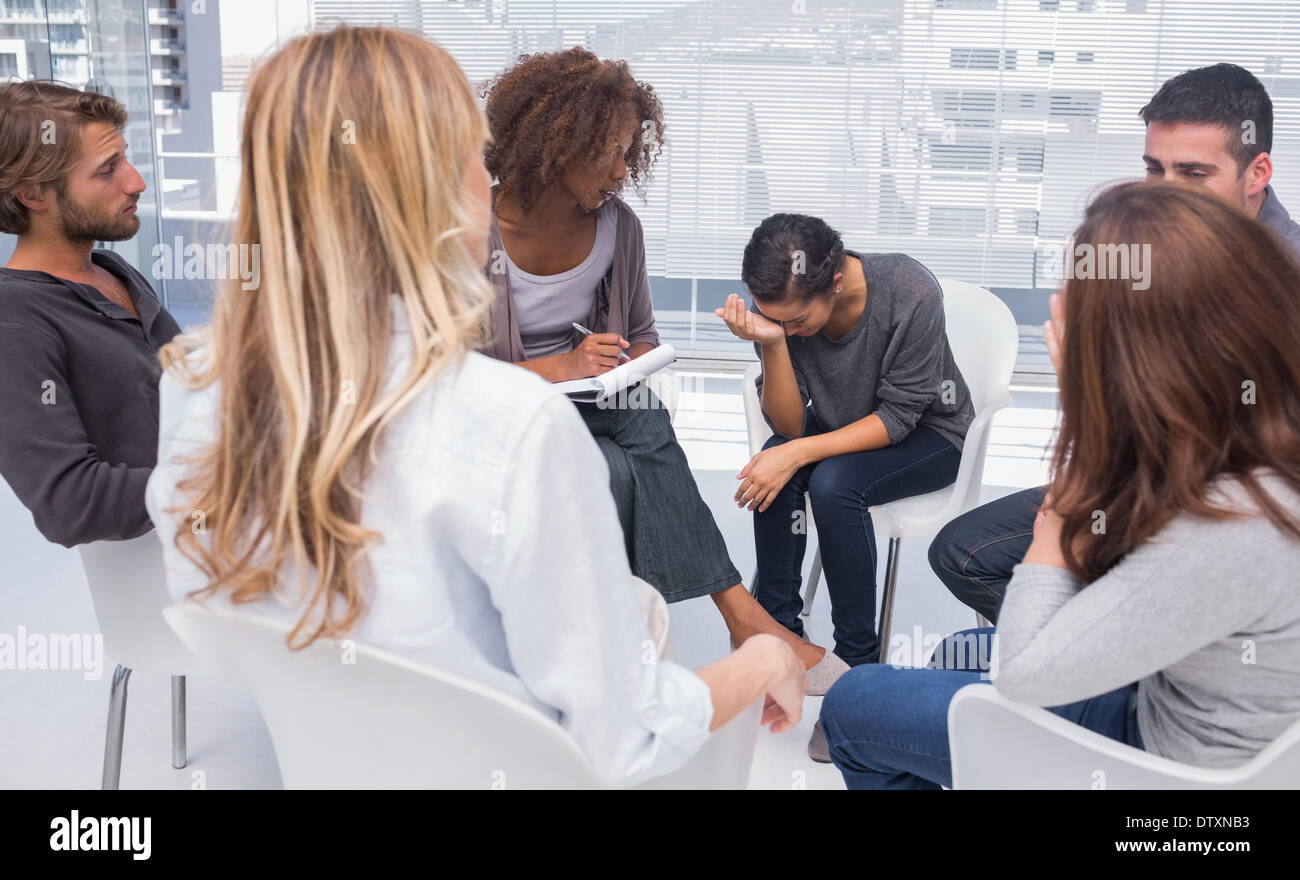 Group therapy session with one woman crying Stock Photo - Alamy