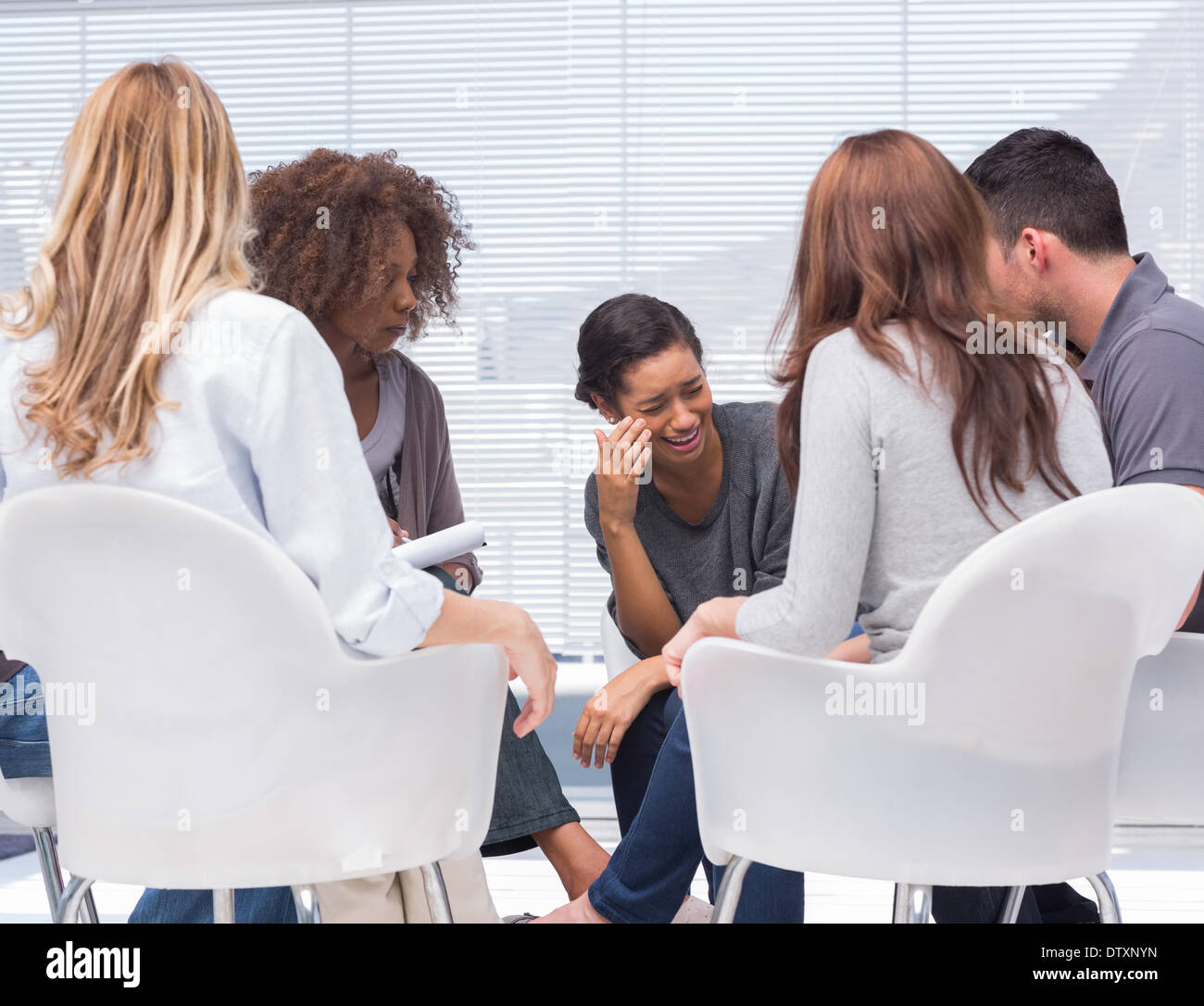 Therapist taking notes while patient crying Stock Photo - Alamy