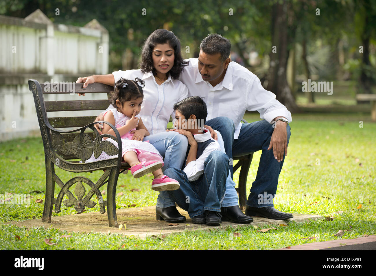 indian family sitting on the bench in the park Stock Photo - Alamy