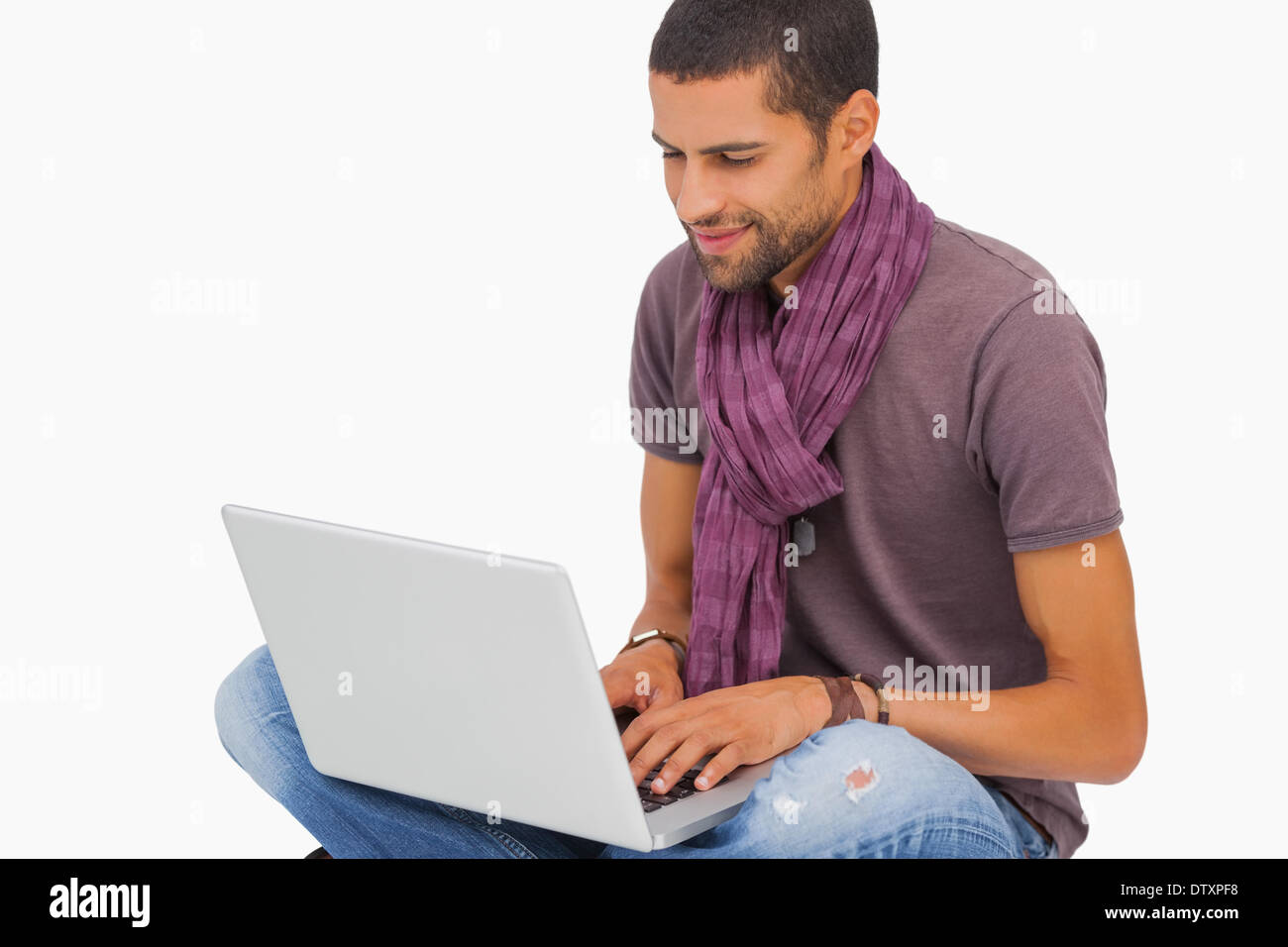 Smiling man sitting on floor using laptop Stock Photo - Alamy