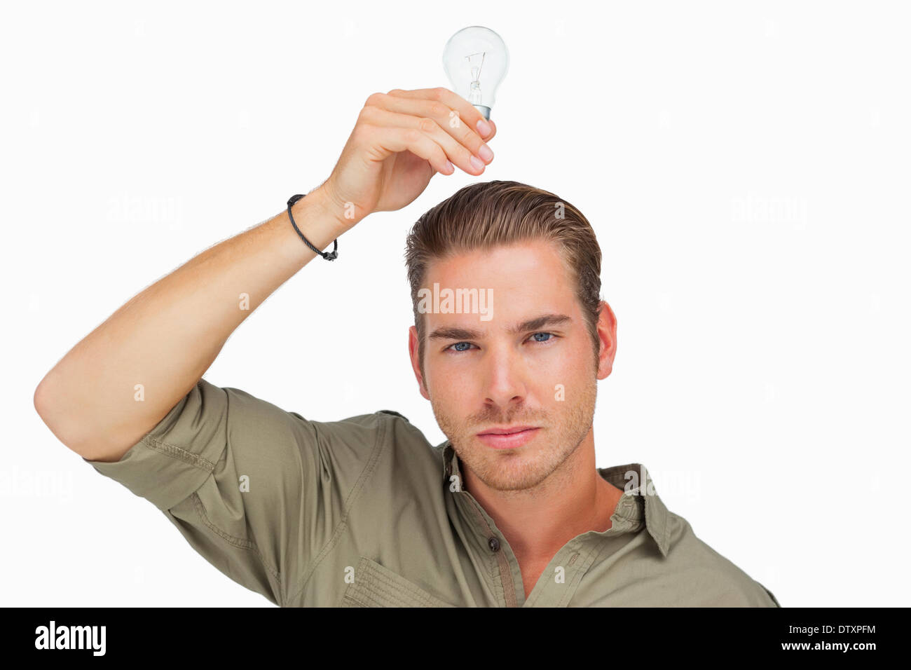 Man holding light bulb above his head Stock Photo - Alamy