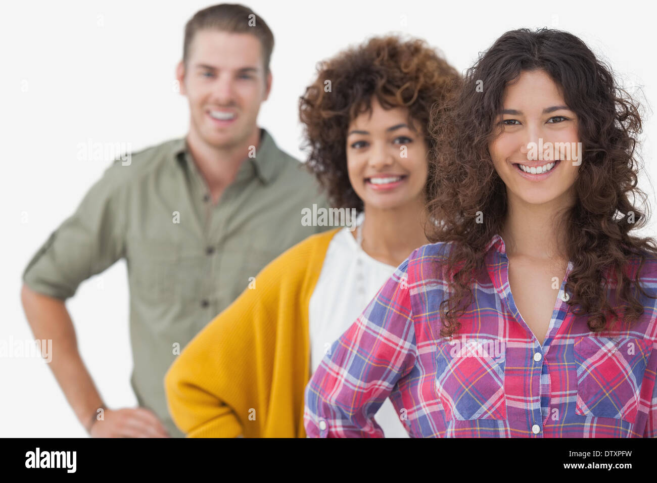 Three stylish friends standing in a row Stock Photo - Alamy