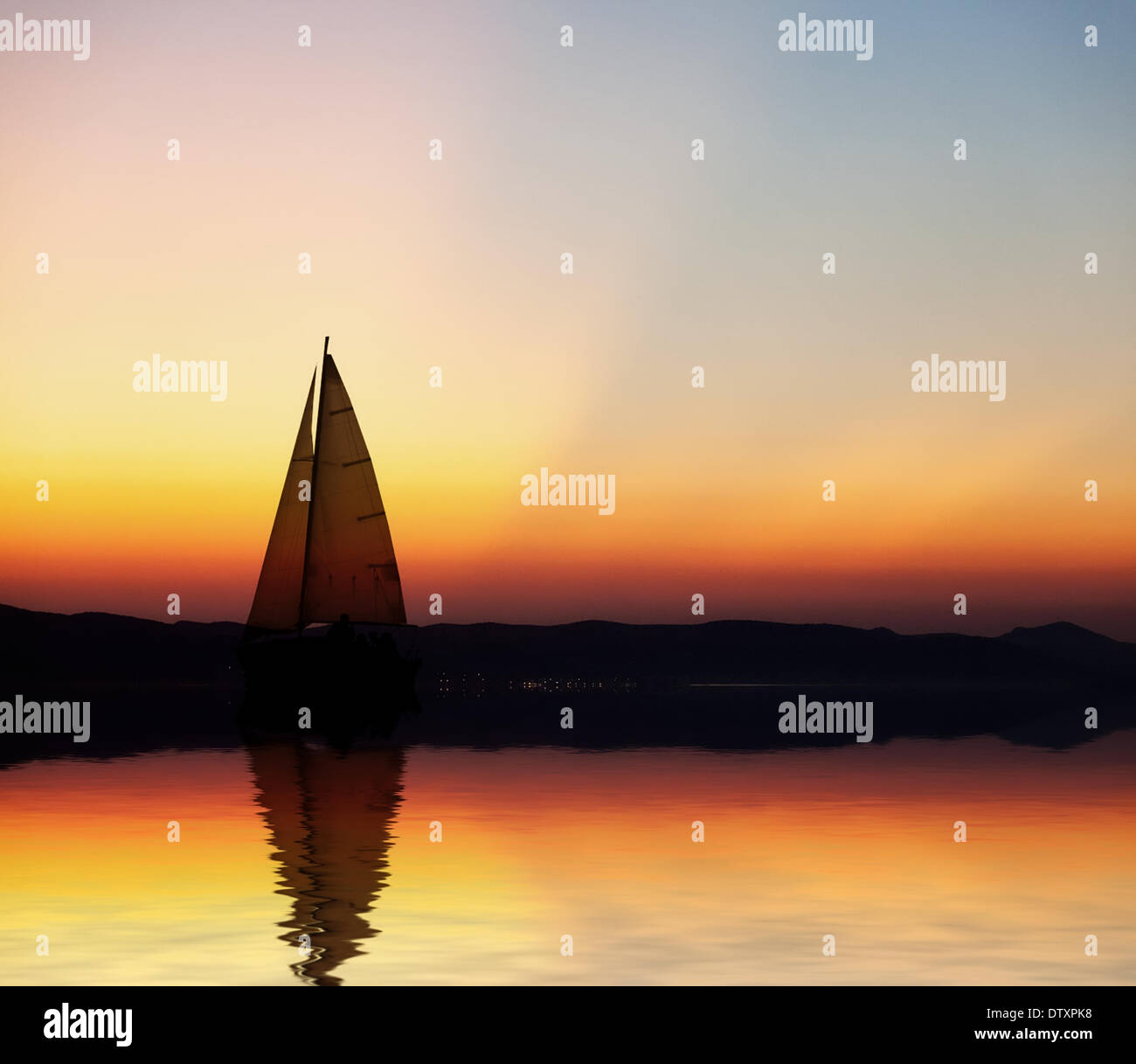 Sailboat at sunset Stock Photo - Alamy