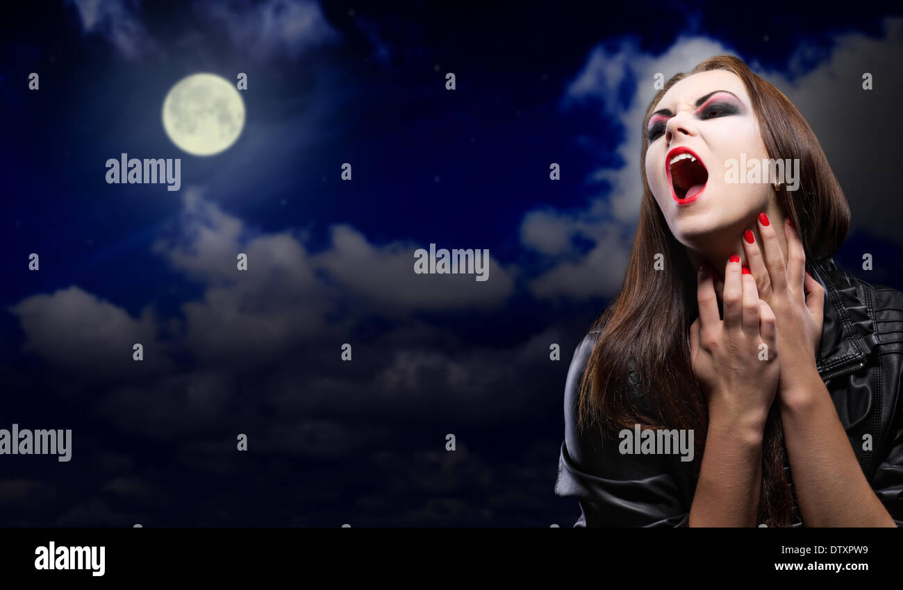 Vampire girl on night sky background Stock Photo - Alamy