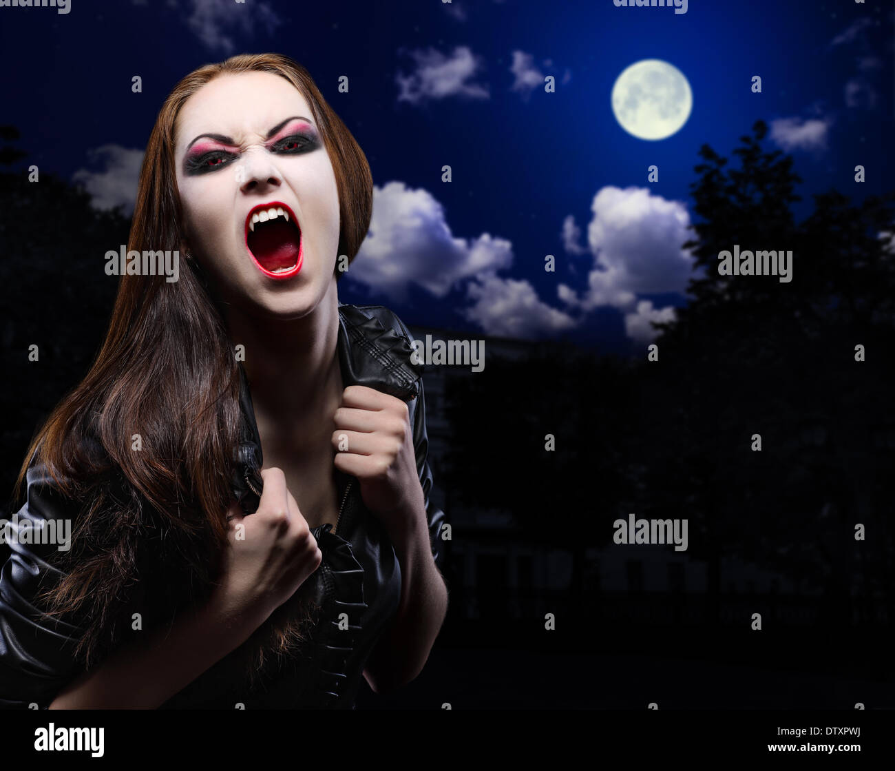 Vampire girl on night sky background Stock Photo - Alamy